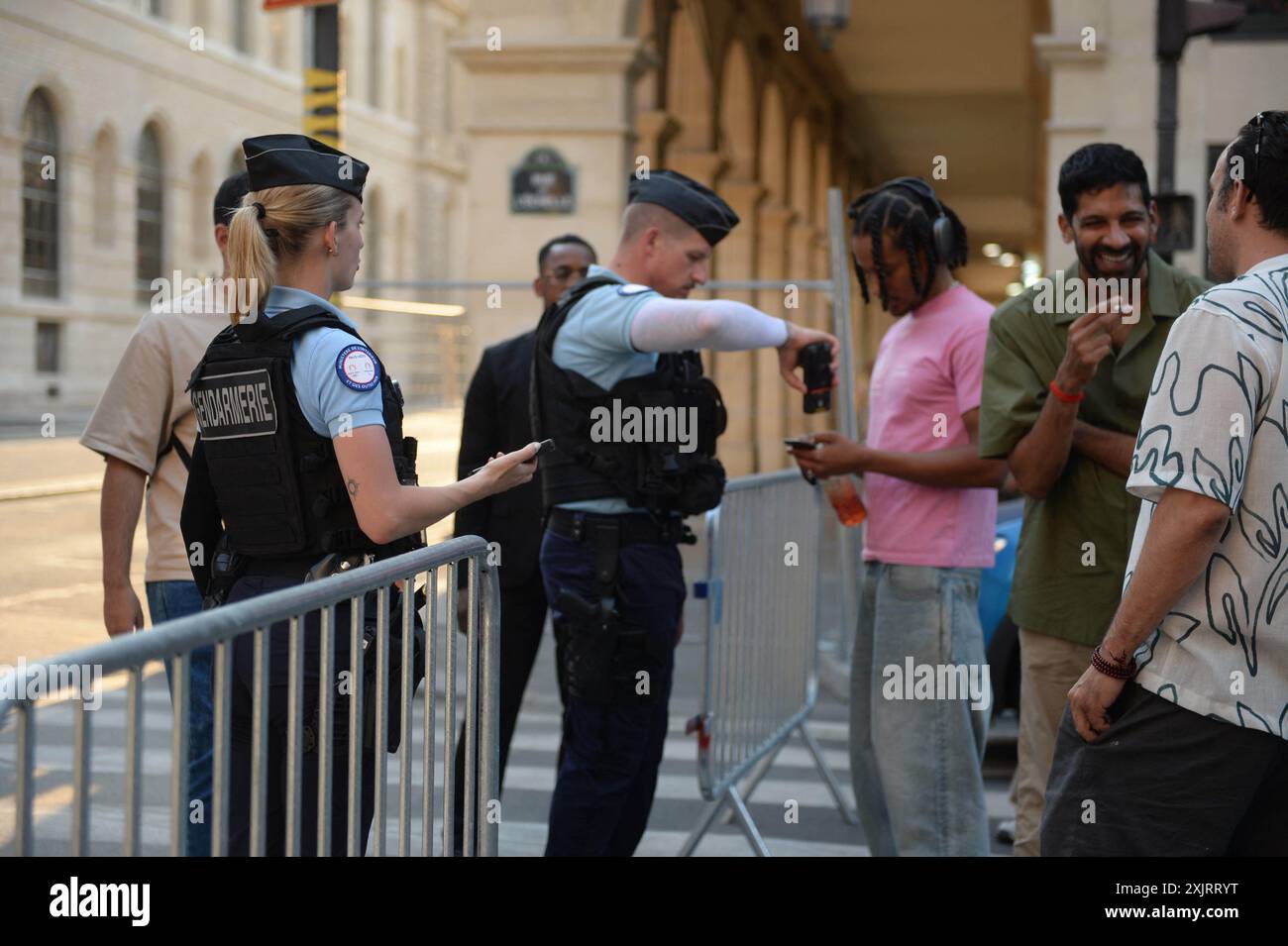 Gendarmerie officers check pedestrians QR codes at a barriers ...
