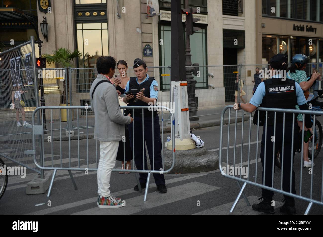 Gendarmerie officers check pedestrians QR codes at a barriers ...