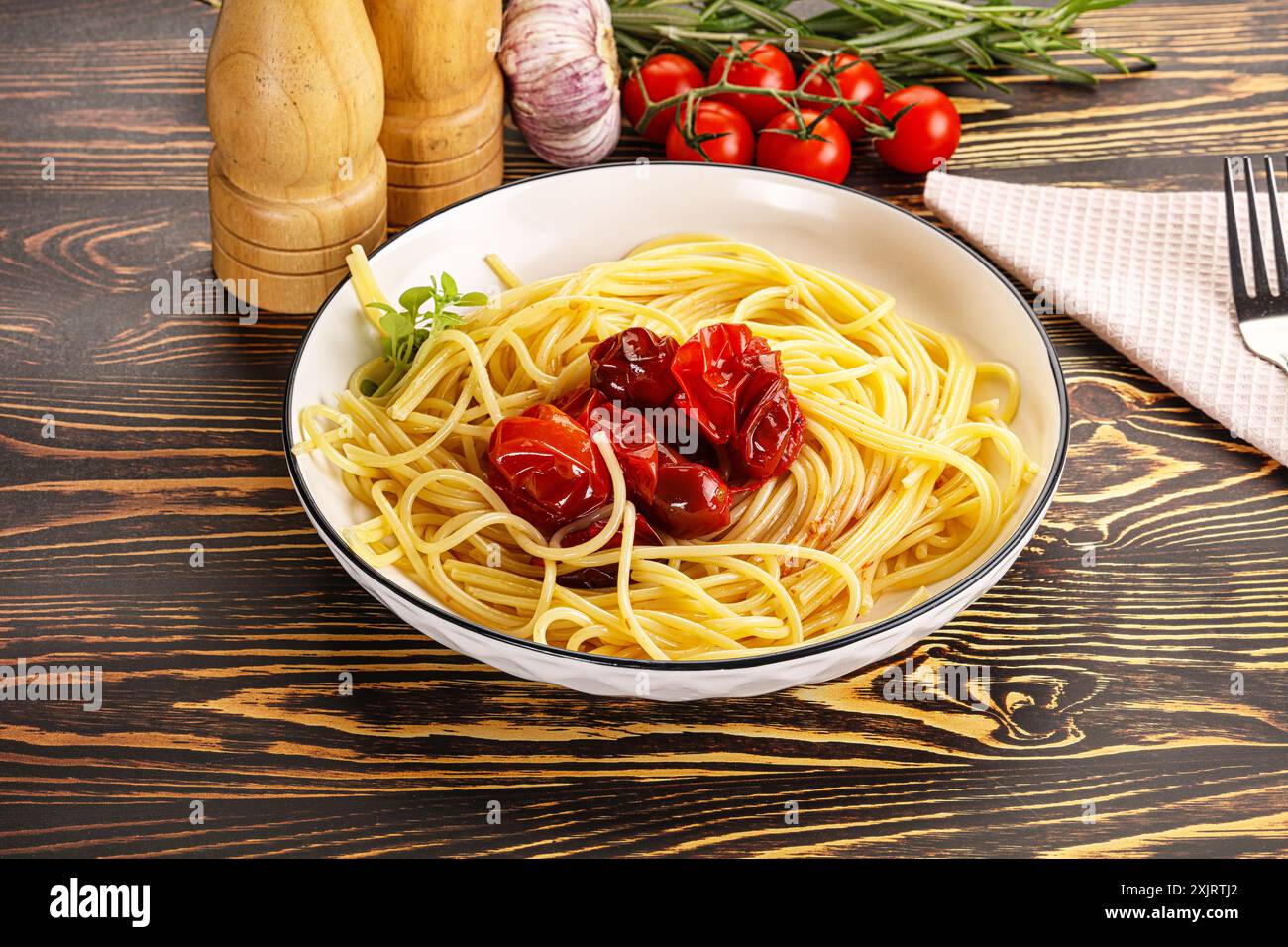 Italian pasta spaghetti with baked tomato Stock Photo - Alamy