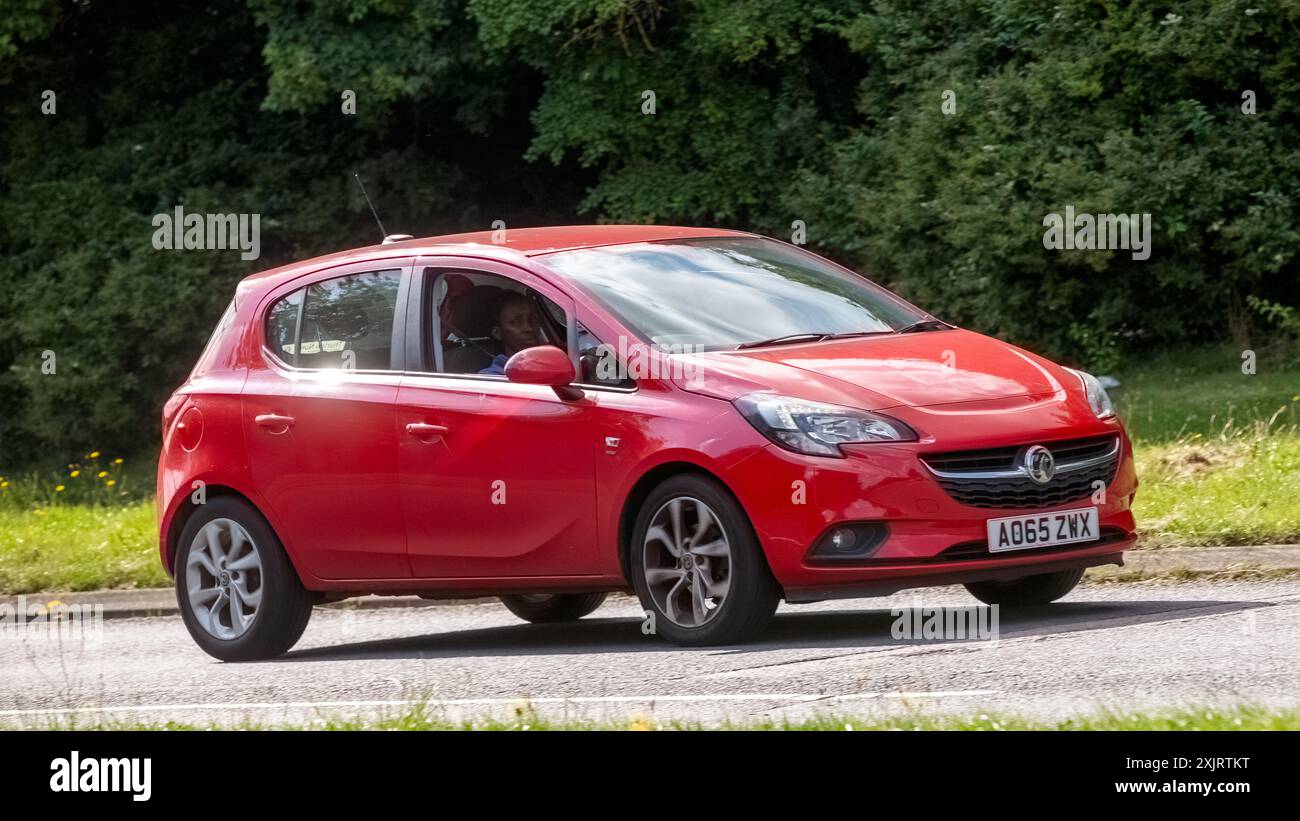 Milton Keynes,UK - July 18th 2024: 2015 red Vauxhall Corsa car driving ...