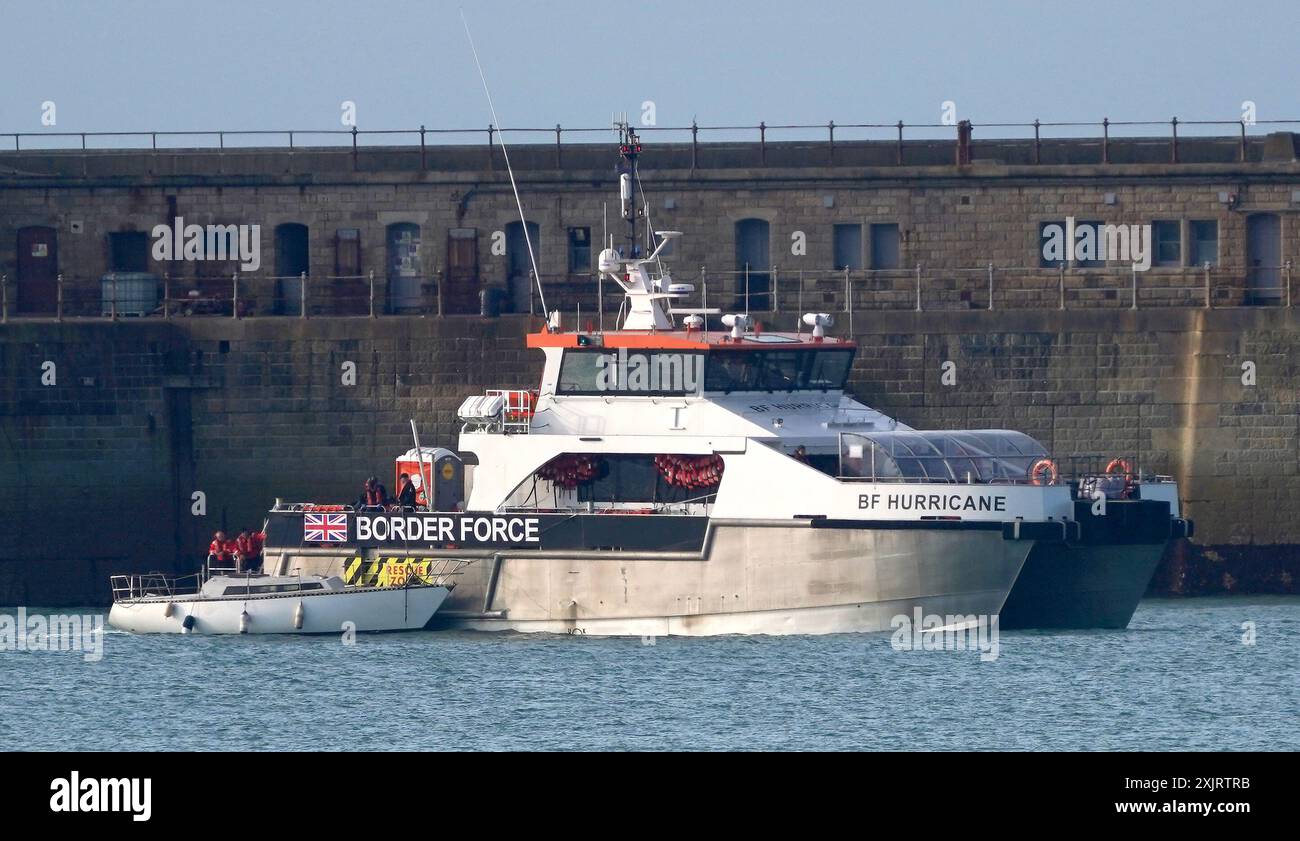 A Border Force vessel tows a yacht in to Dover, Kent, following a small ...