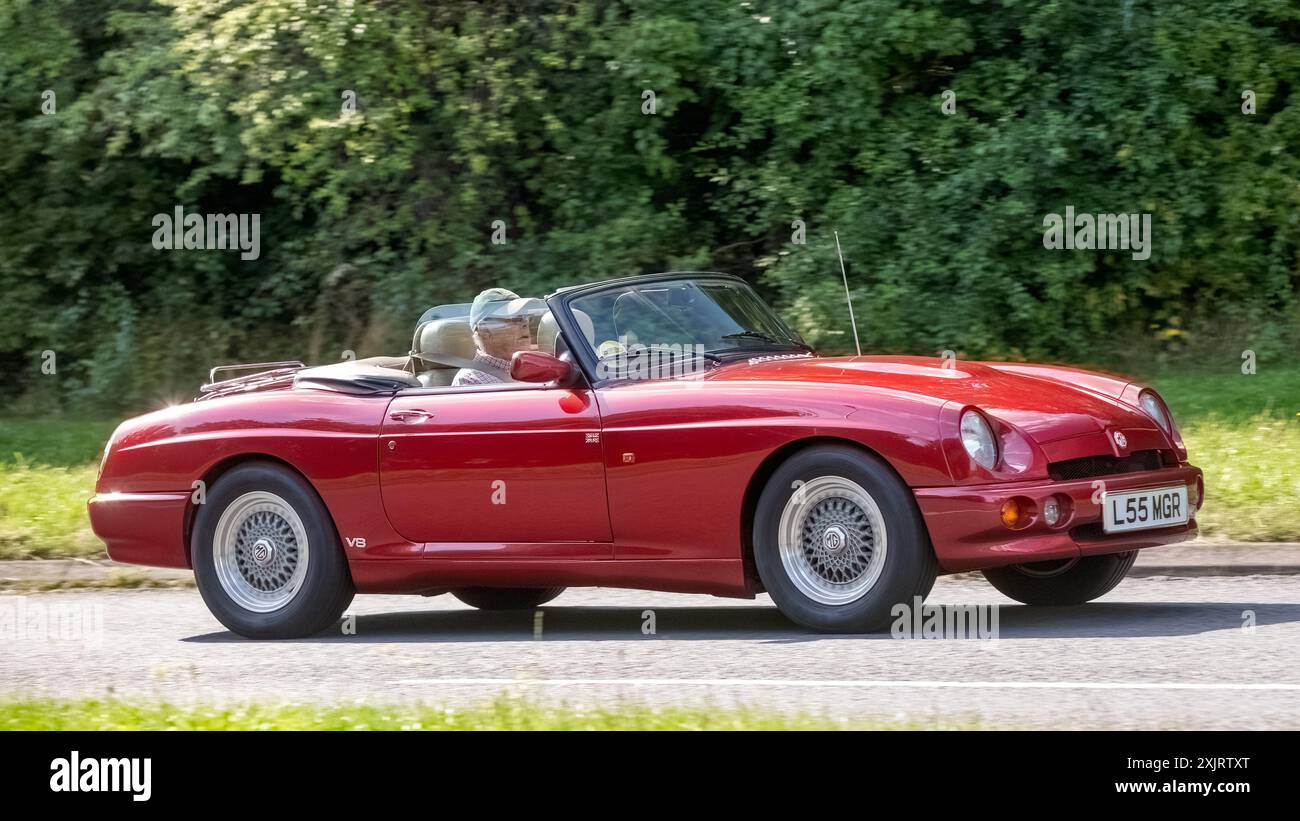 Milton Keynes,UK - July 18th 2024: 1993 red MG RV8 car driving on a ...