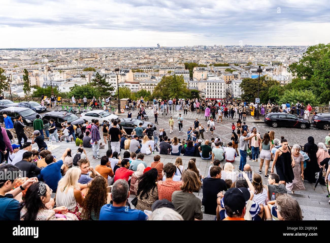 Overtourism in Paris. Crowds of tourists along the stairs of Basilica ...