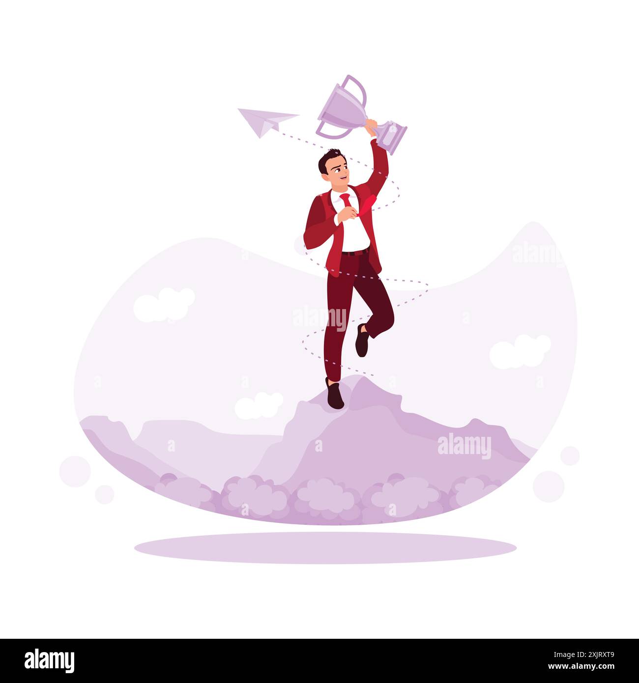 The young businessman is holding a trophy and standing on the mountain ...