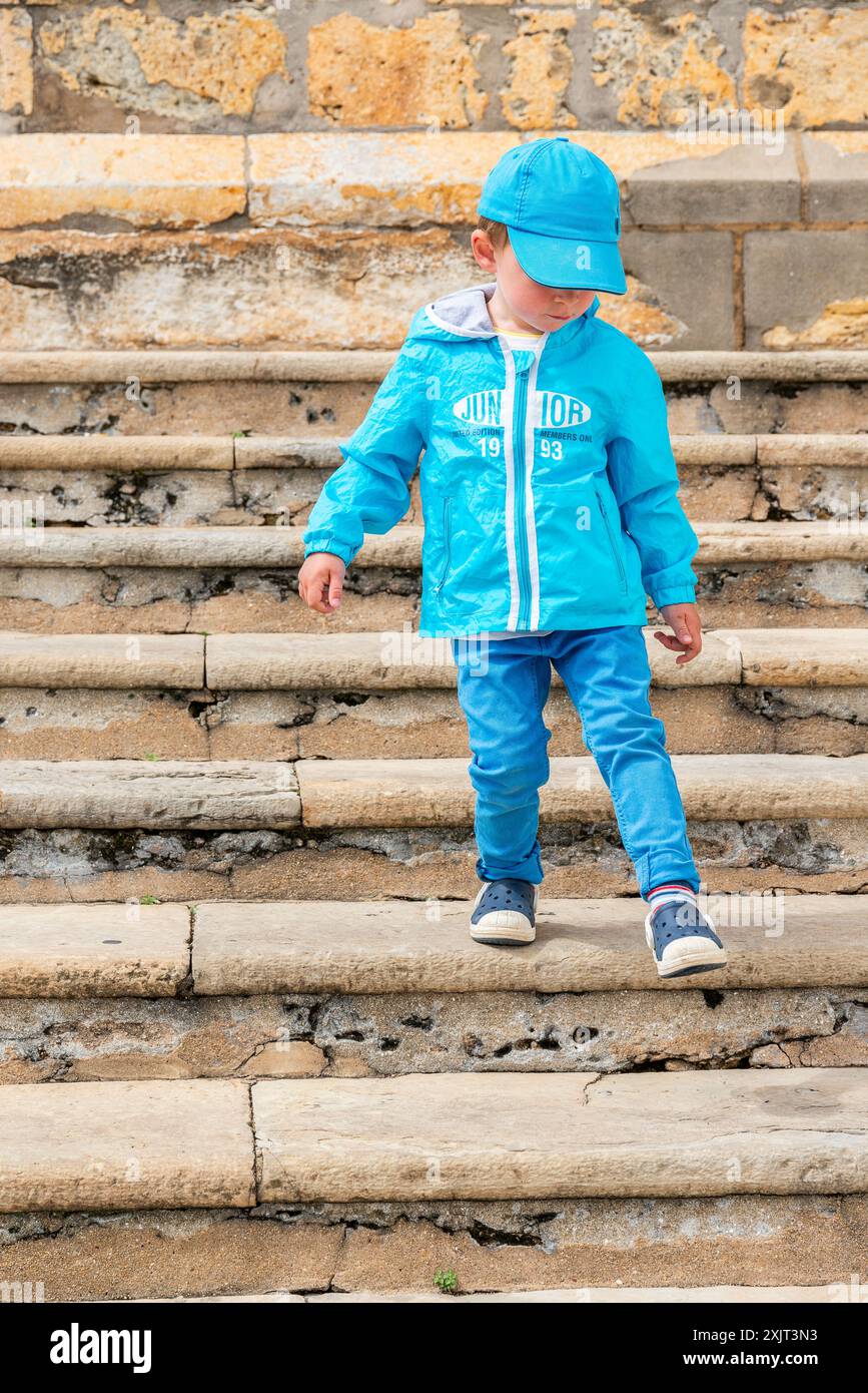 Young Boy in Blue Descending Steps, Old Town of Faro, Portugal Stock ...