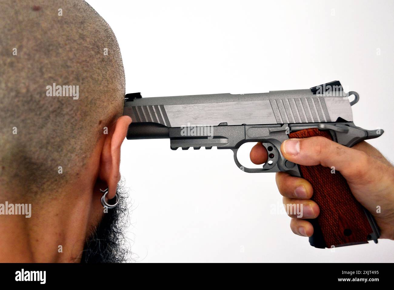 Man being threatened in the head with a semi-automatic handgun Stock ...