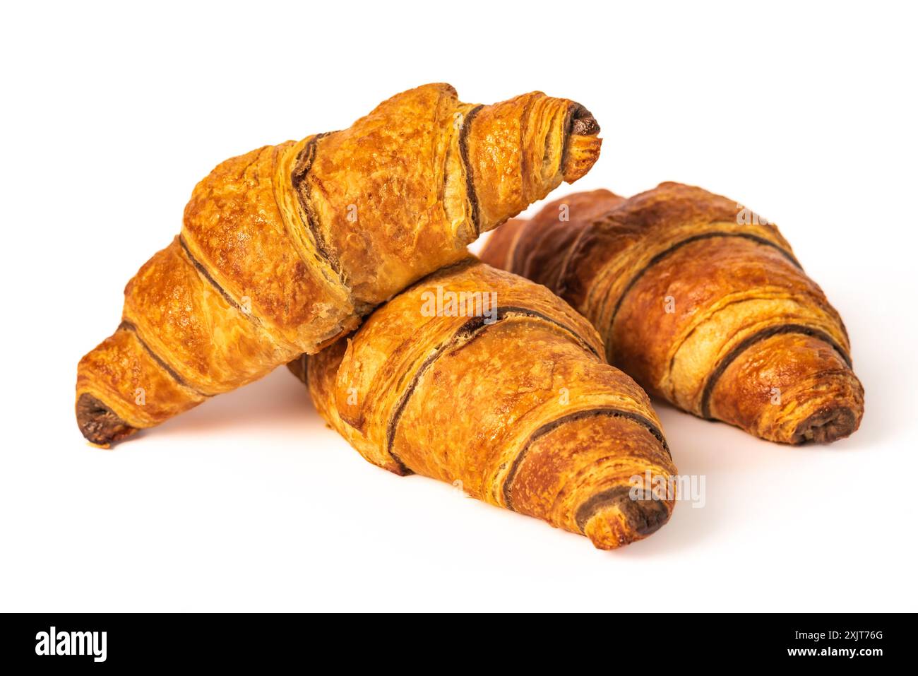 A trio of perfectly baked croissants, golden brown and flaky, are ...