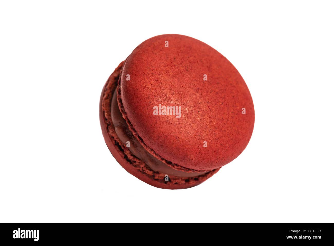 A single, red macaron with a strawberry filling is shown in a close-up ...