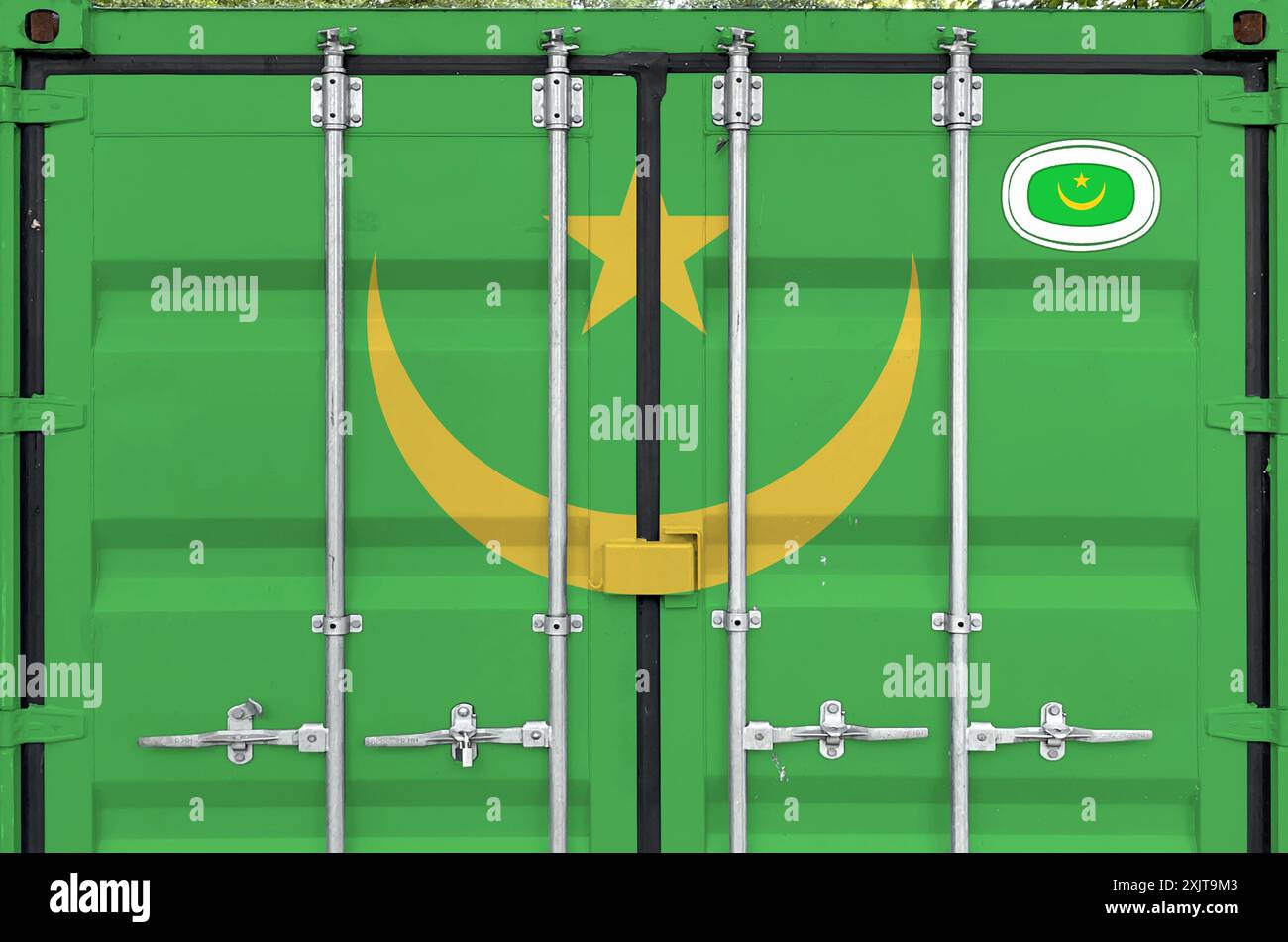 Mauritania flag depicted on metal doors of shipping cargo container outdoors in docks area close ...