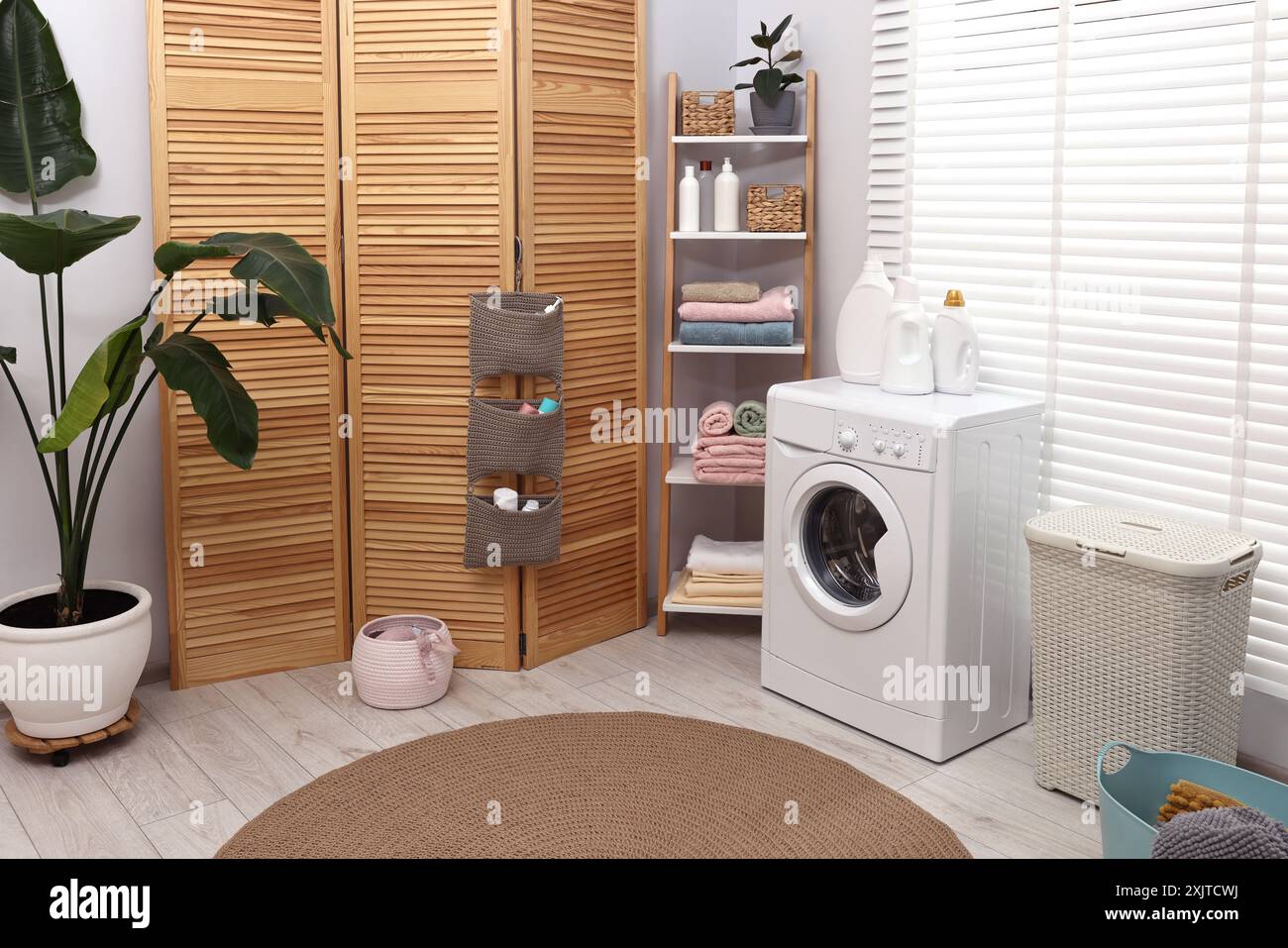 Washing machine, folding screen, detergents, towels and basket in ...