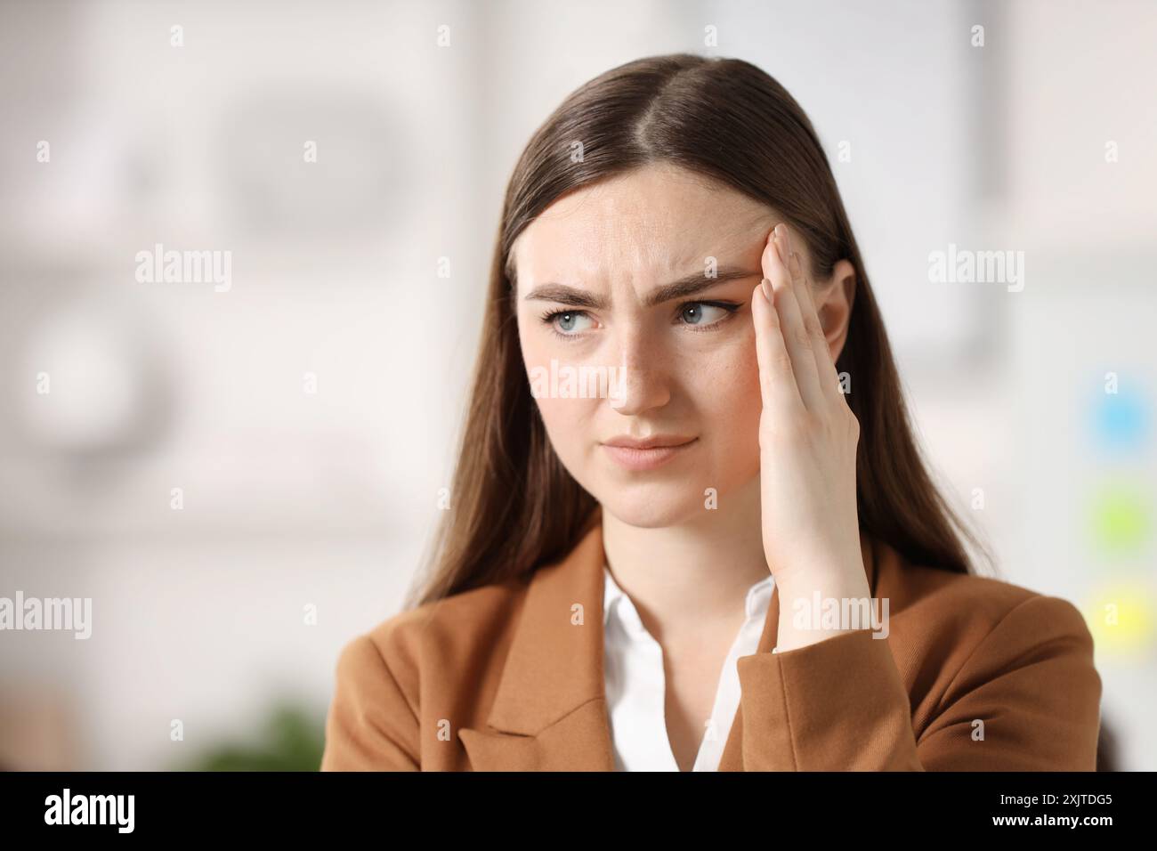 Embarrassed woman in office, space for text Stock Photo - Alamy