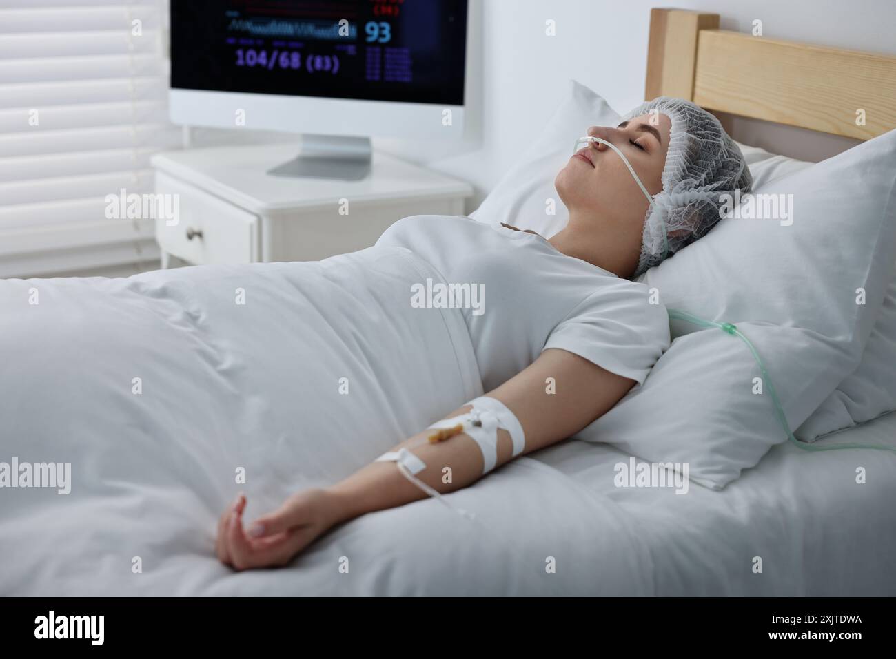 Coma patient. Young woman with intravenous drip in hospital bed Stock Photo - Alamy