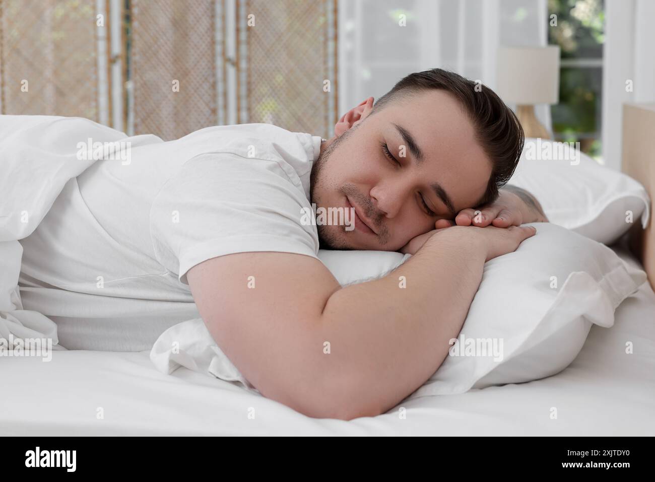 Bedtime. Handsome man sleeping in bed indoors Stock Photo - Alamy