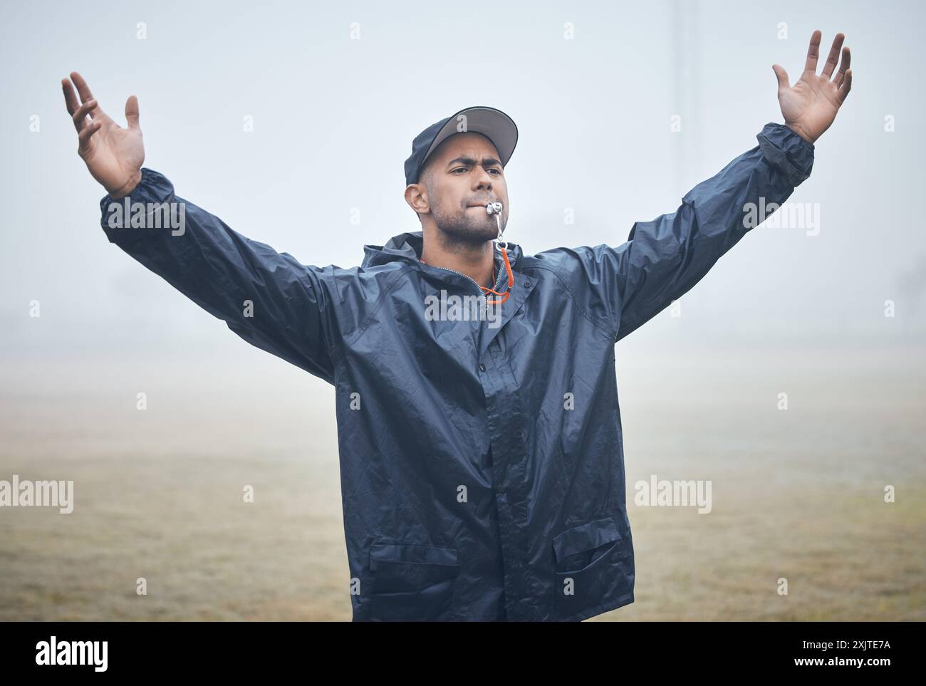 Sports, man and referee blowing whistle on field for warning, foul and ...
