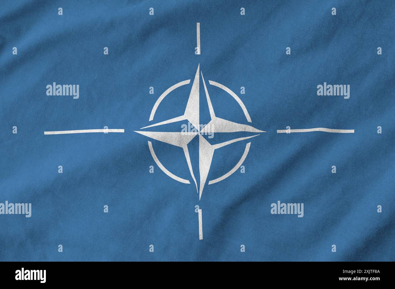Nato flag depicted on folded wavy fabric of old cloth close up Stock ...