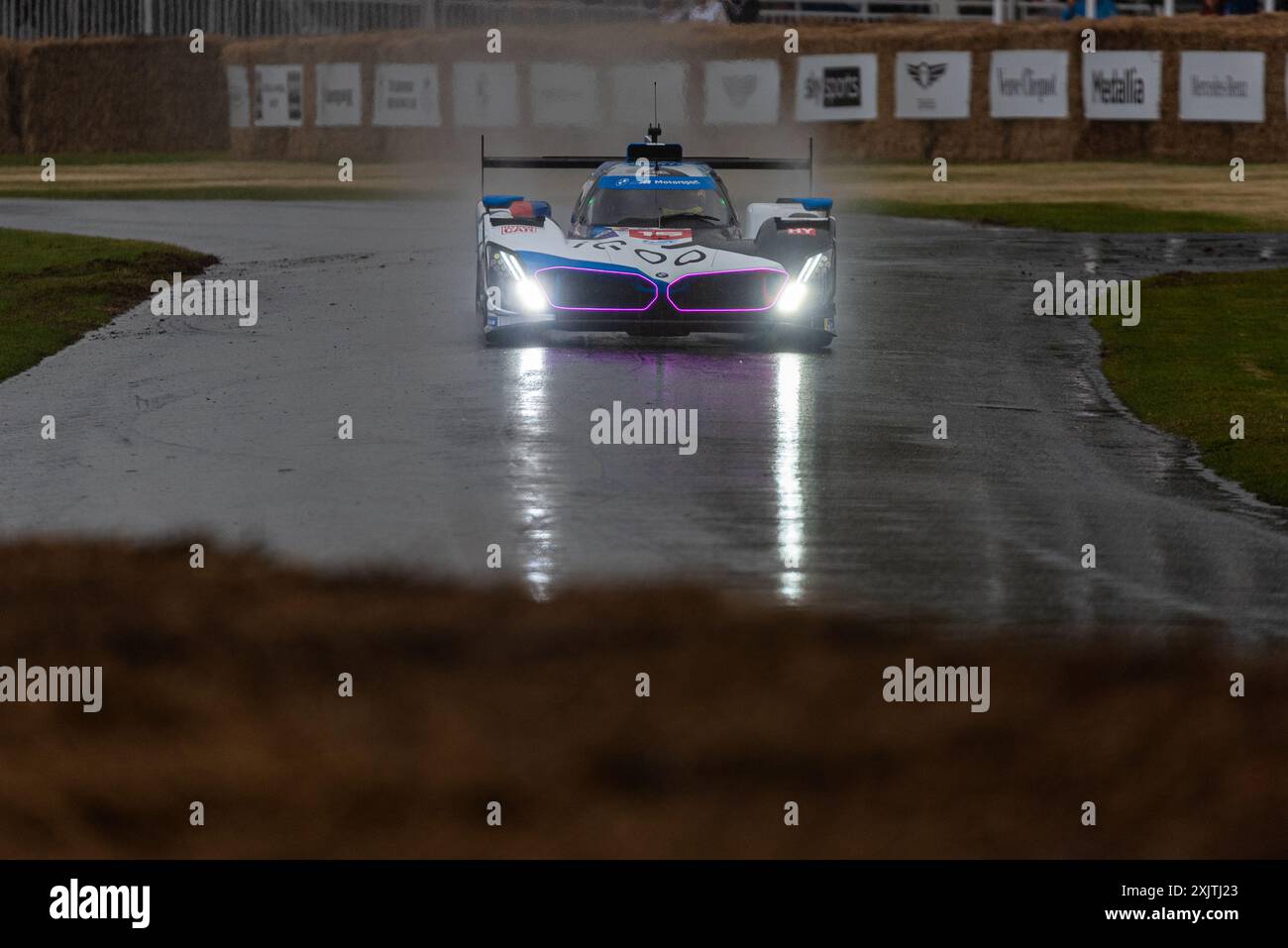 BMW M Hybrid V8 Le Mans Daytona h class race car driving up the hill climb track at the Goodwood ...