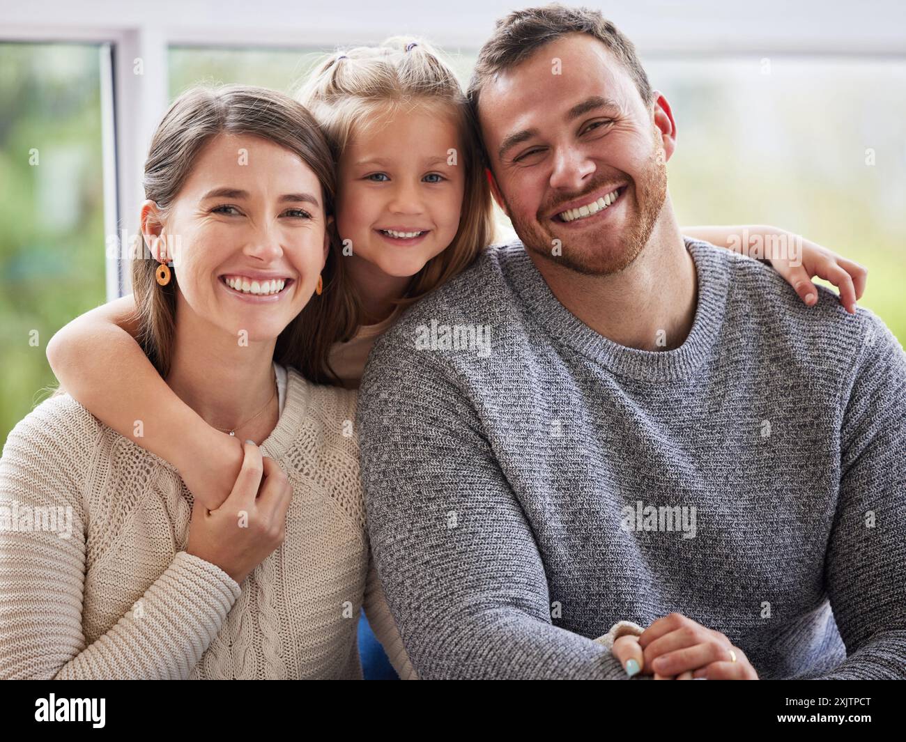 Parents, portrait and girl child in home for love, care or bonding ...