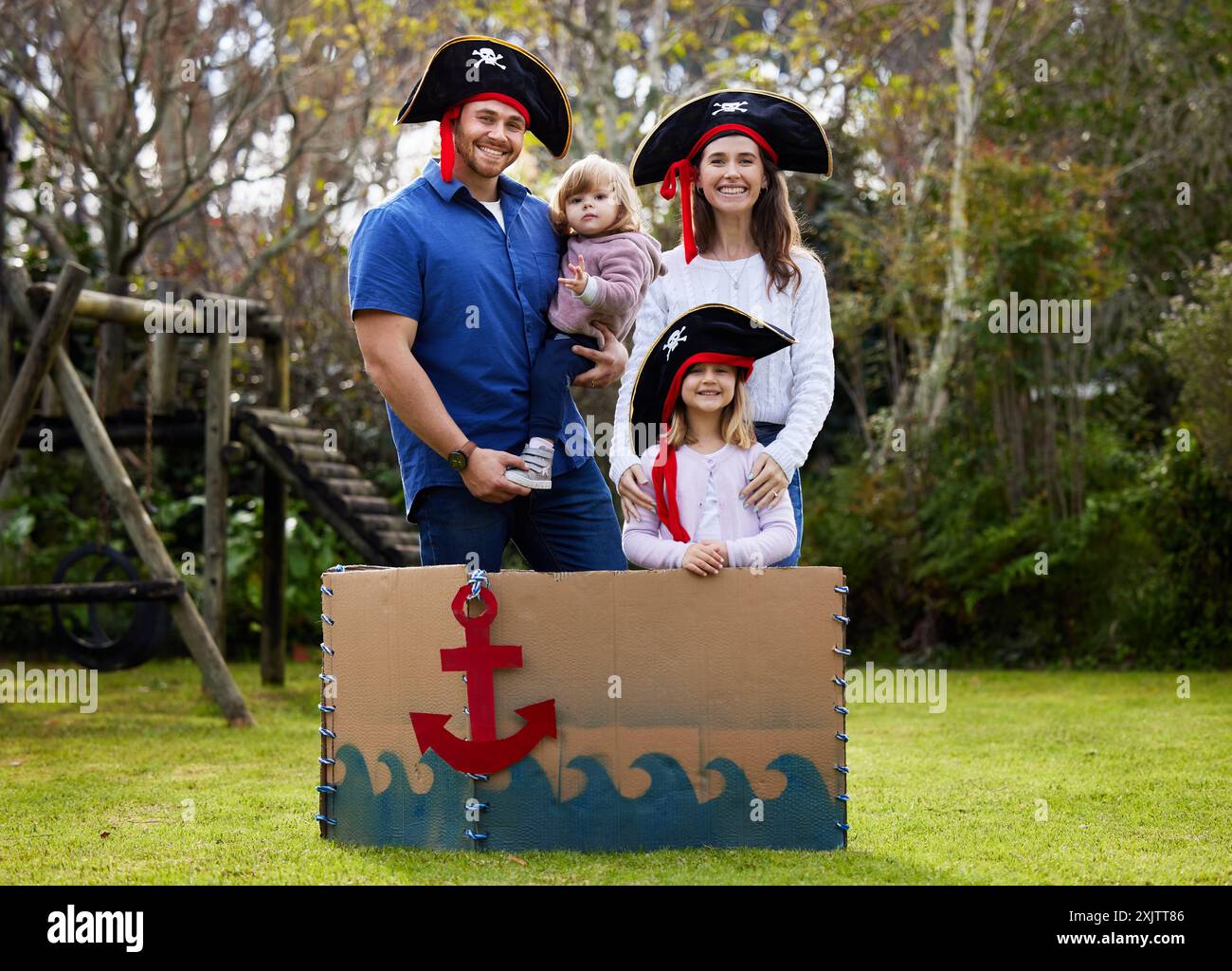 Portrait, pirate and parents with children in park for playing, pretend ...