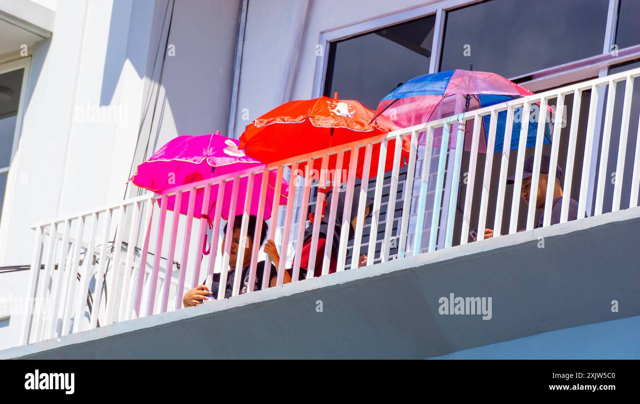 People on the balcony a with white building Stock Photo - Alamy