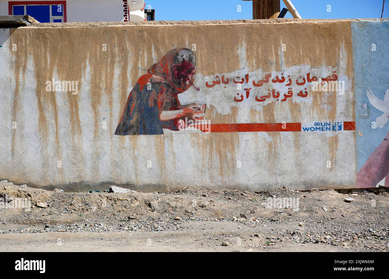 A defaced street mural in Afghanistan: a woman's face is crossed out in ...