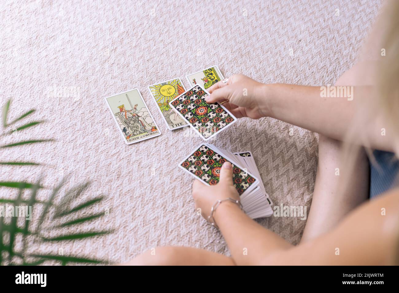 Young woman lays out tarot cards Stock Photo - Alamy