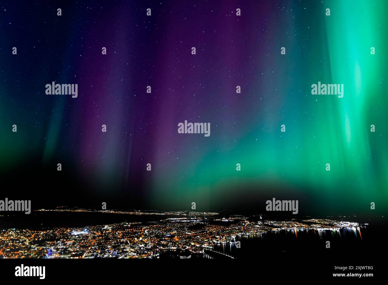 The Northern Lights over Tromso city, Troms county, Norway Stock Photo ...