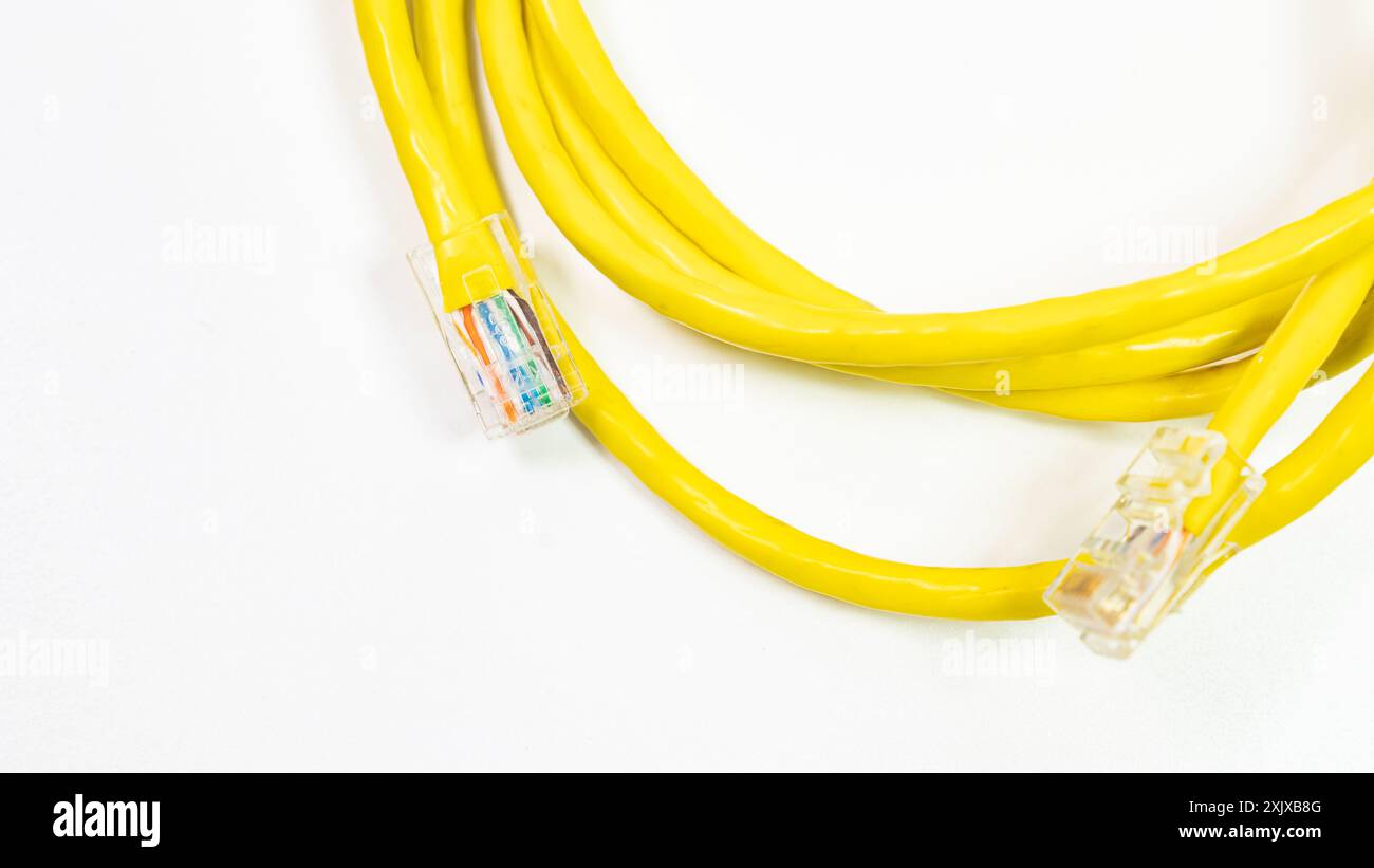 A yellow cable with a white background Stock Photo - Alamy
