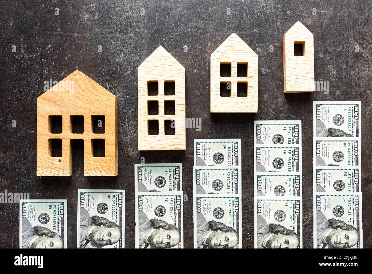 Rising real estate prices. 100 dollar bills stacked upwards. Increasing ...