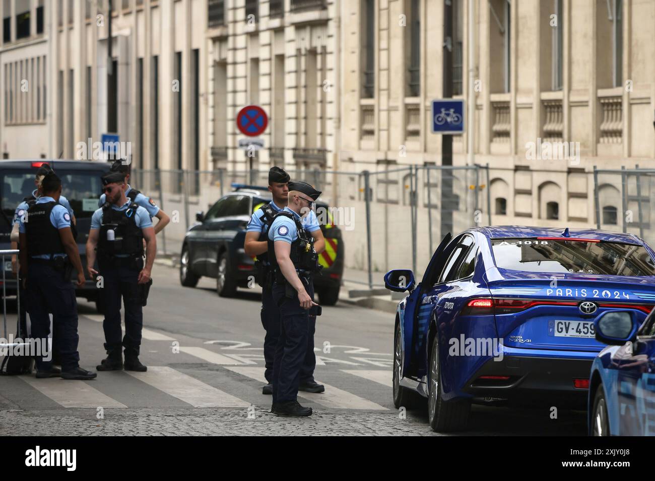 Police officers check an accredited vehicle for Paris olympics at the ...