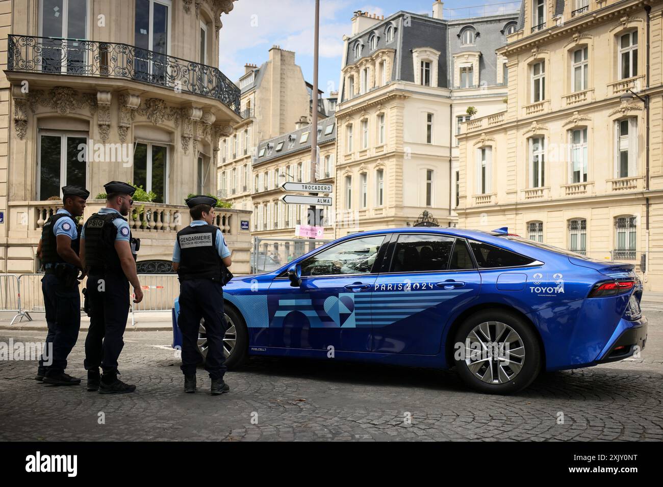 Police officers check an accredited vehicle for Paris olympics at the ...