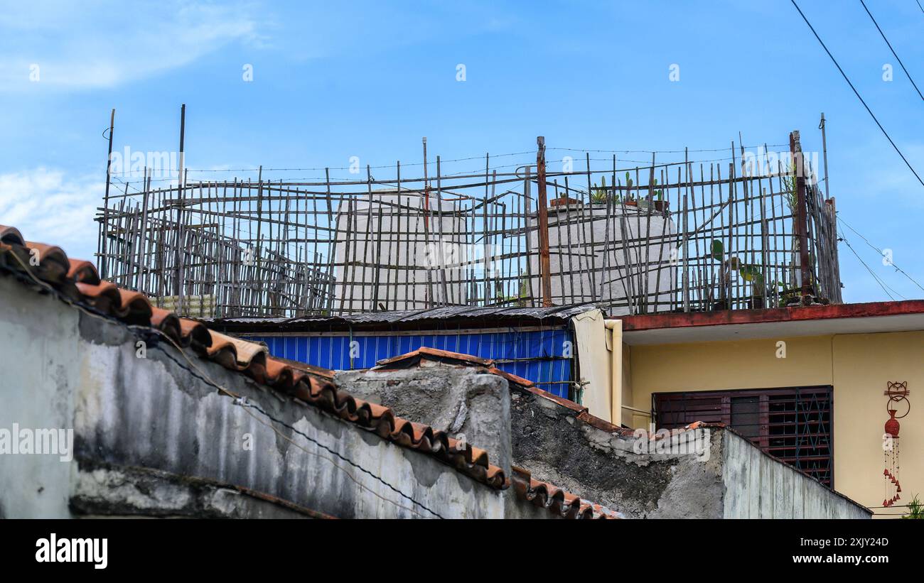 A rustic fence protecting two water storage tanks on a rooftop, Santa ...