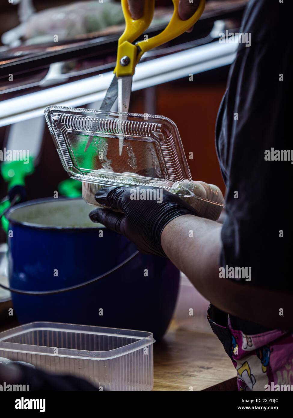Person Cutting Open Plastic Container With Scissors Stock Photo - Alamy