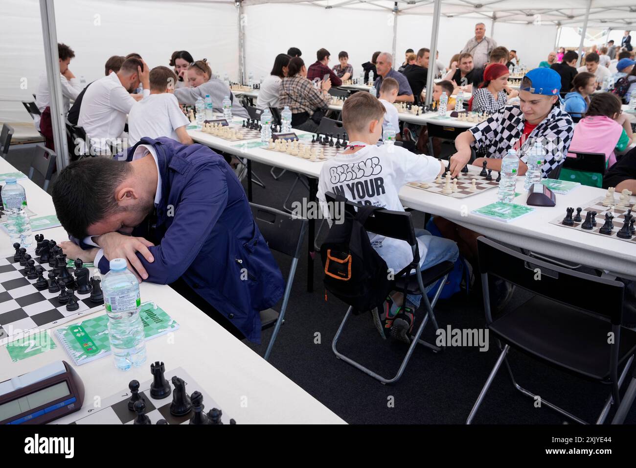 People play chess during the International Chess Day celebration at the ...