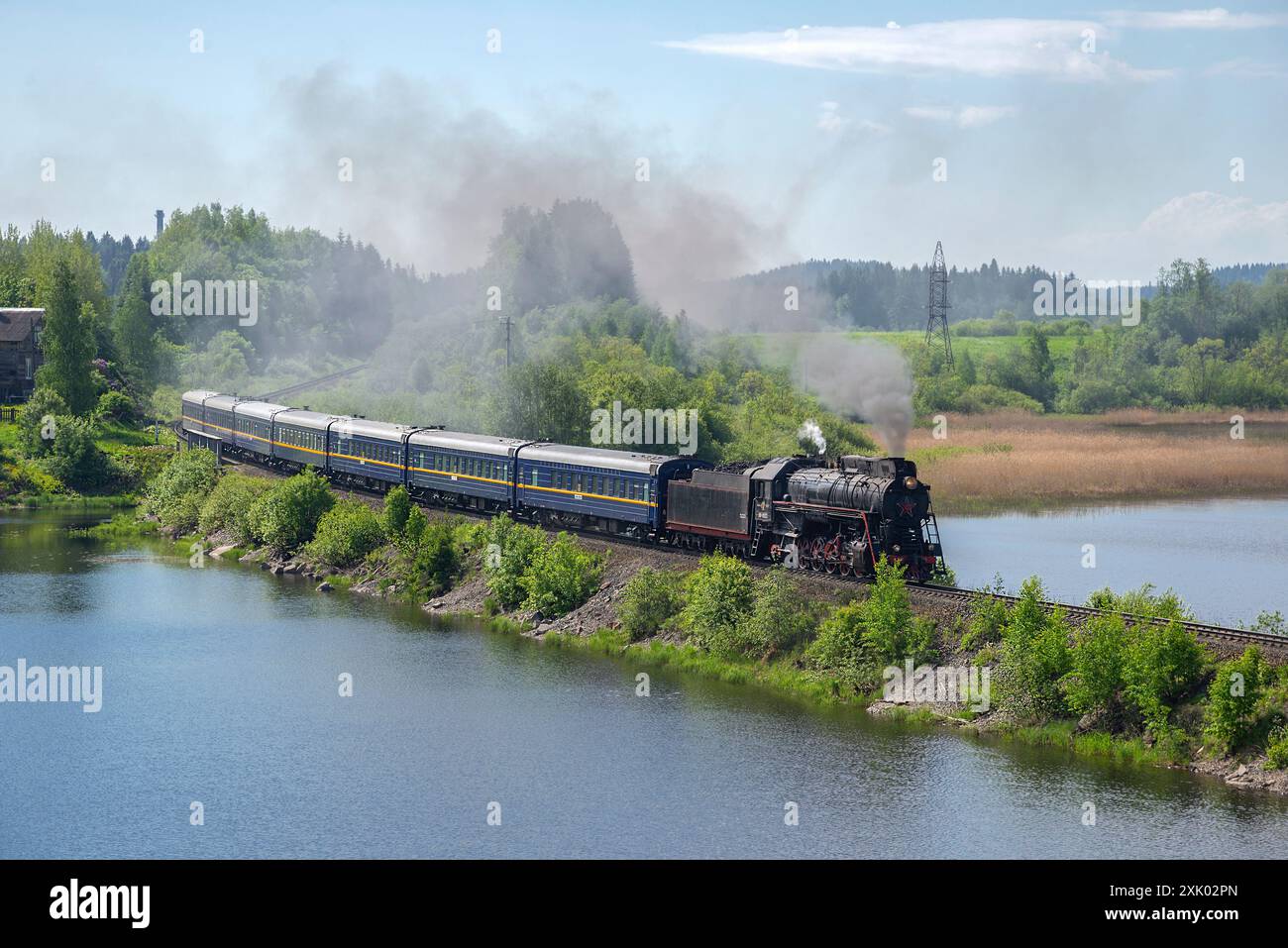 KARELIA, RUSSIA - JUNE 11, 2022: An old steam locomotive with a tourist ...