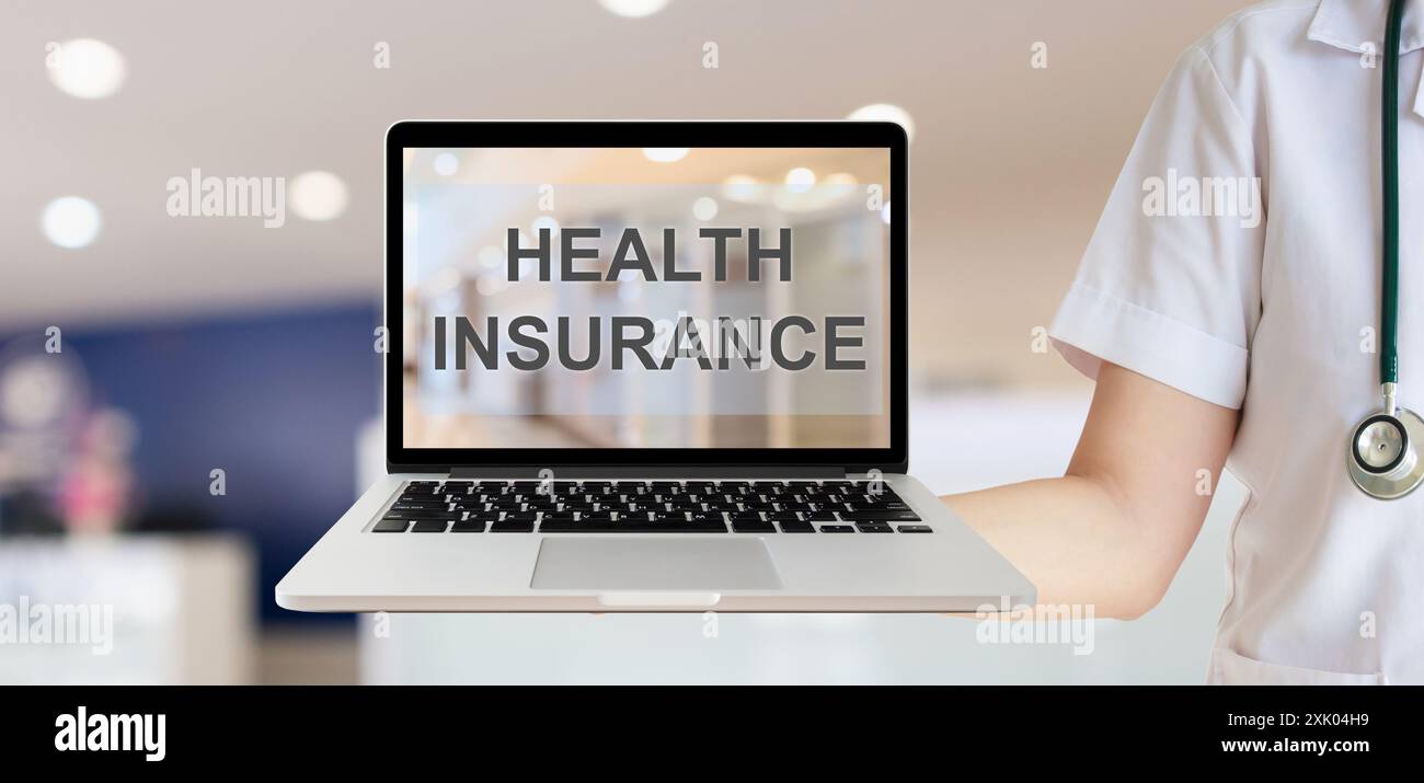 female doctor showing laptop computer with Health Insurance text with ...