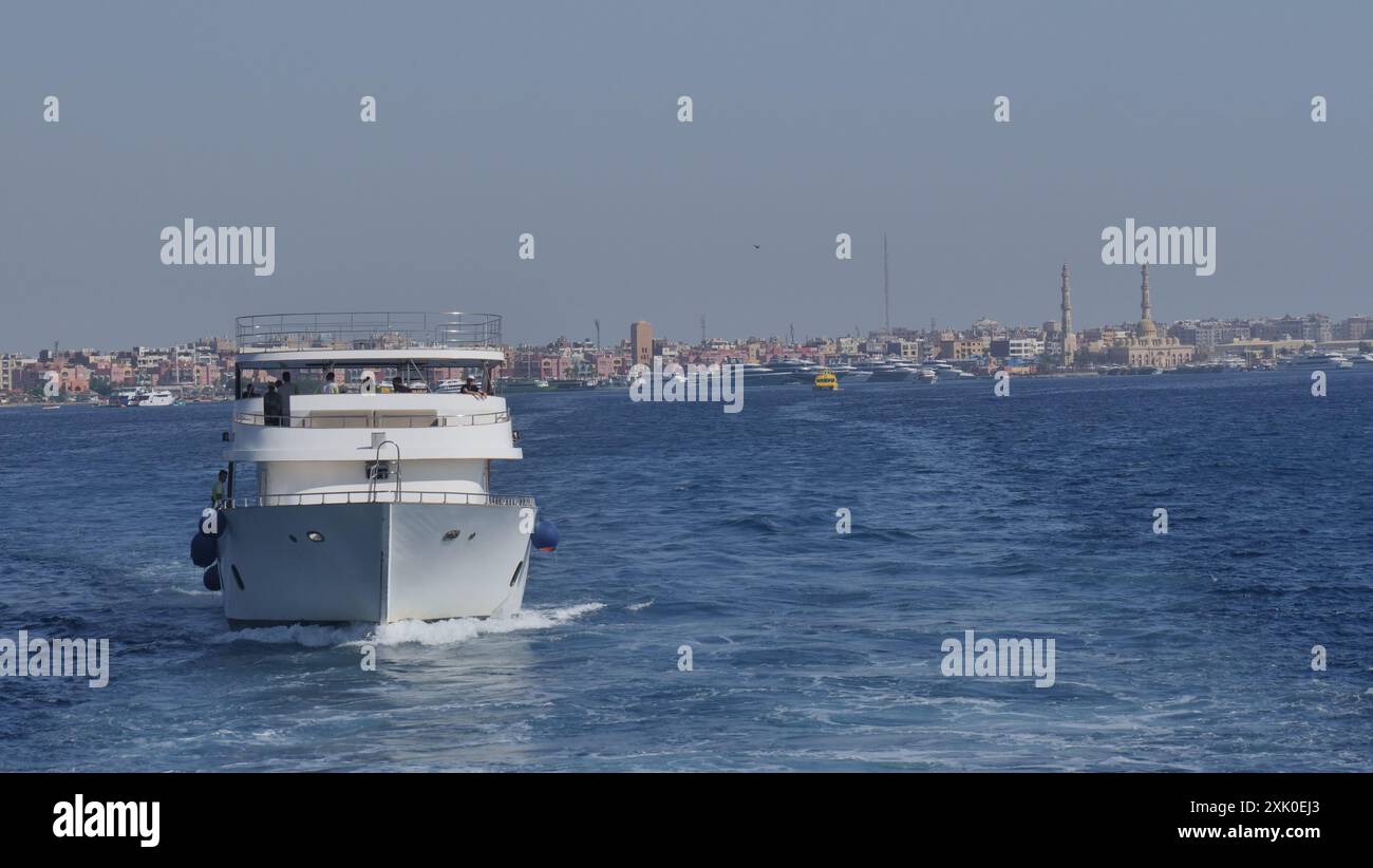 A fleet of boats sail from Hurghada marina, egypt, to take tourists on ...