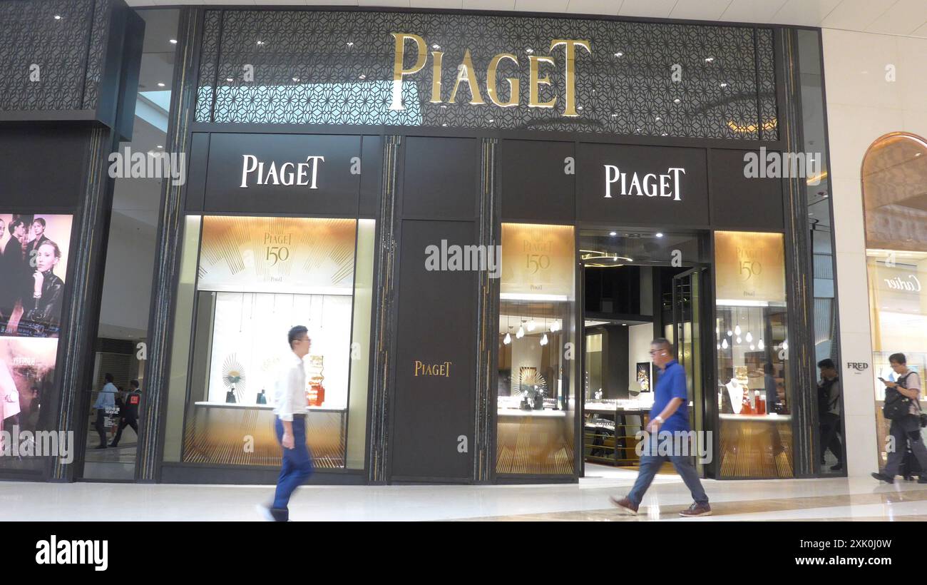Pedestrians walk past the Swiss luxury watchmaker and jeweller Piaget ...