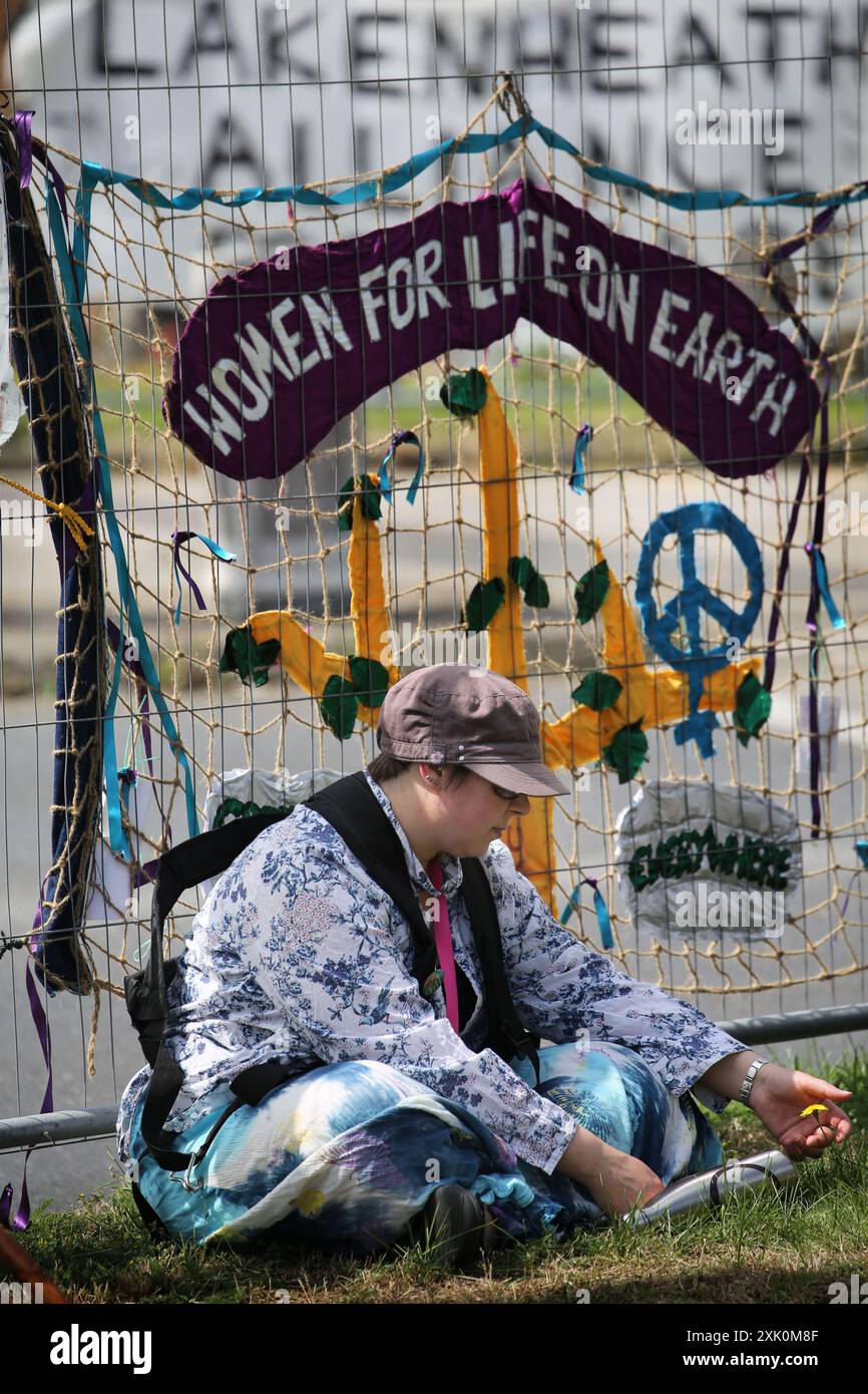 Lakenheath, England, UK. 20th July, 2024. A protester appreciates the ...