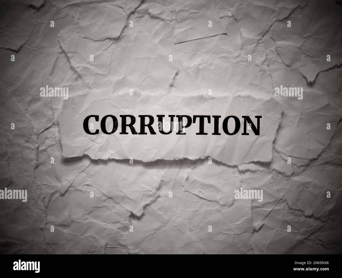 Crumpled piece of paper with word Corruption on a torn white paper ...