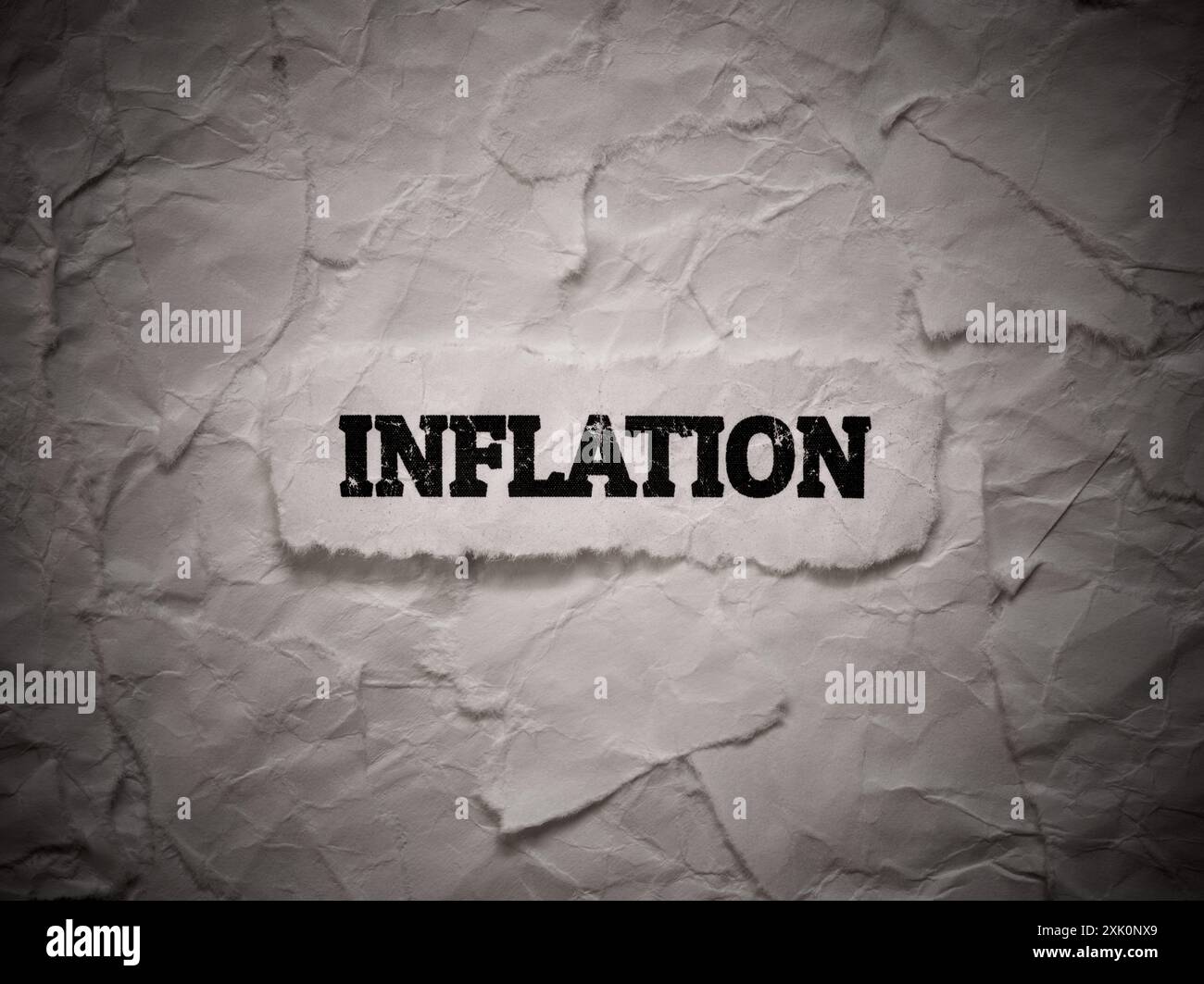 Crumpled piece of paper with word Inflation on a torn white paper ...