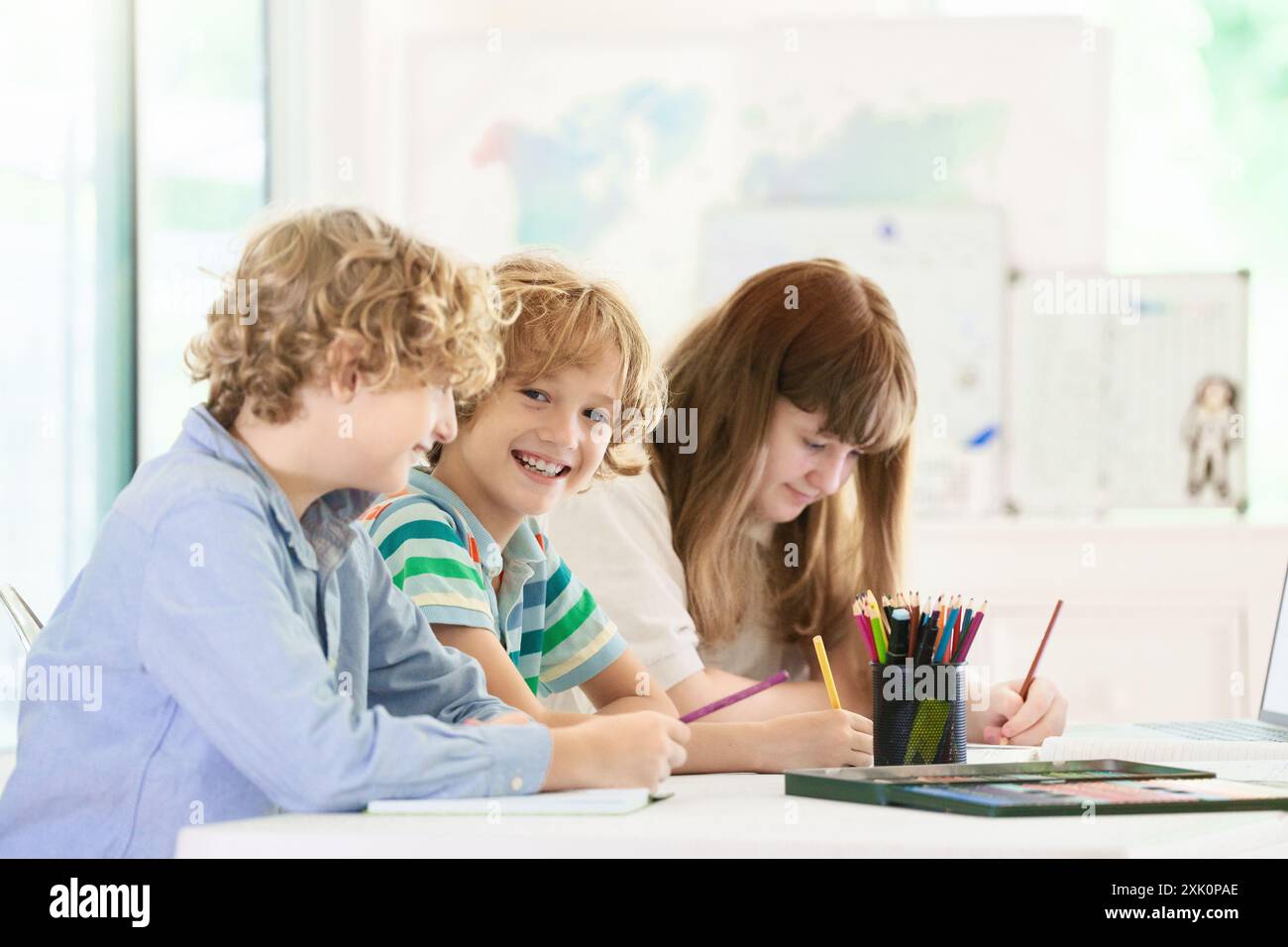 Back to school. Kids and teacher in classroom during math class ...