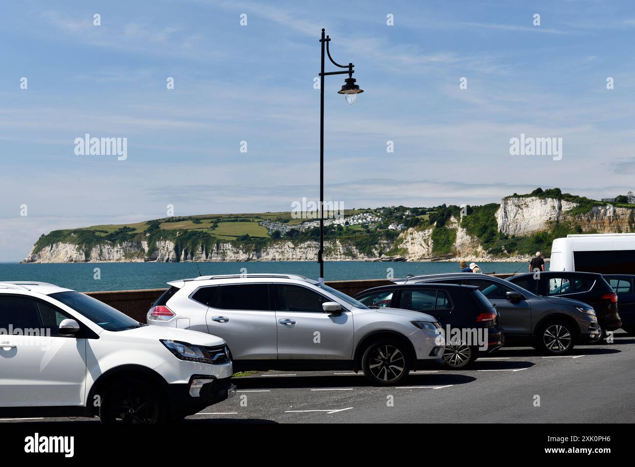 Parked Cars at Seaton Seafront with the Jurassic Coast behind Devon ...