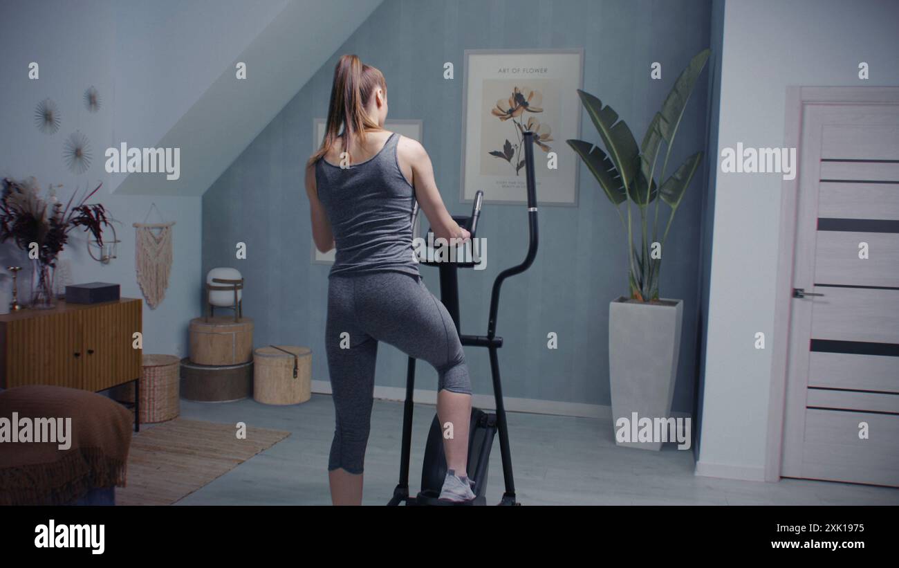 Athletic woman starts training on orbitrek simulator. Virtual reality ...