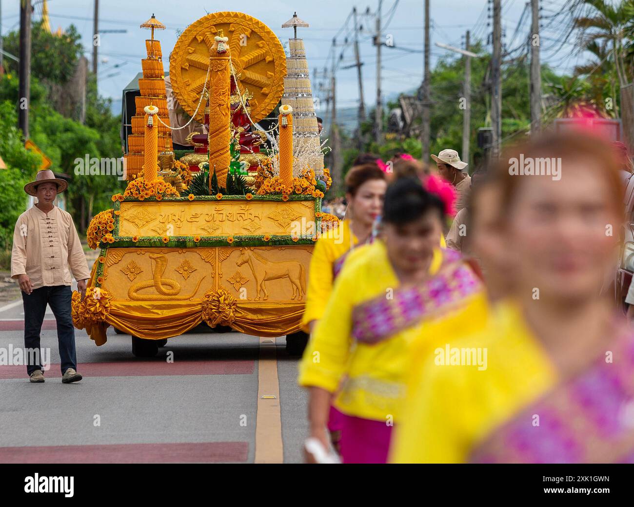 Thai villagers dressed in traditional attire take part during the ...