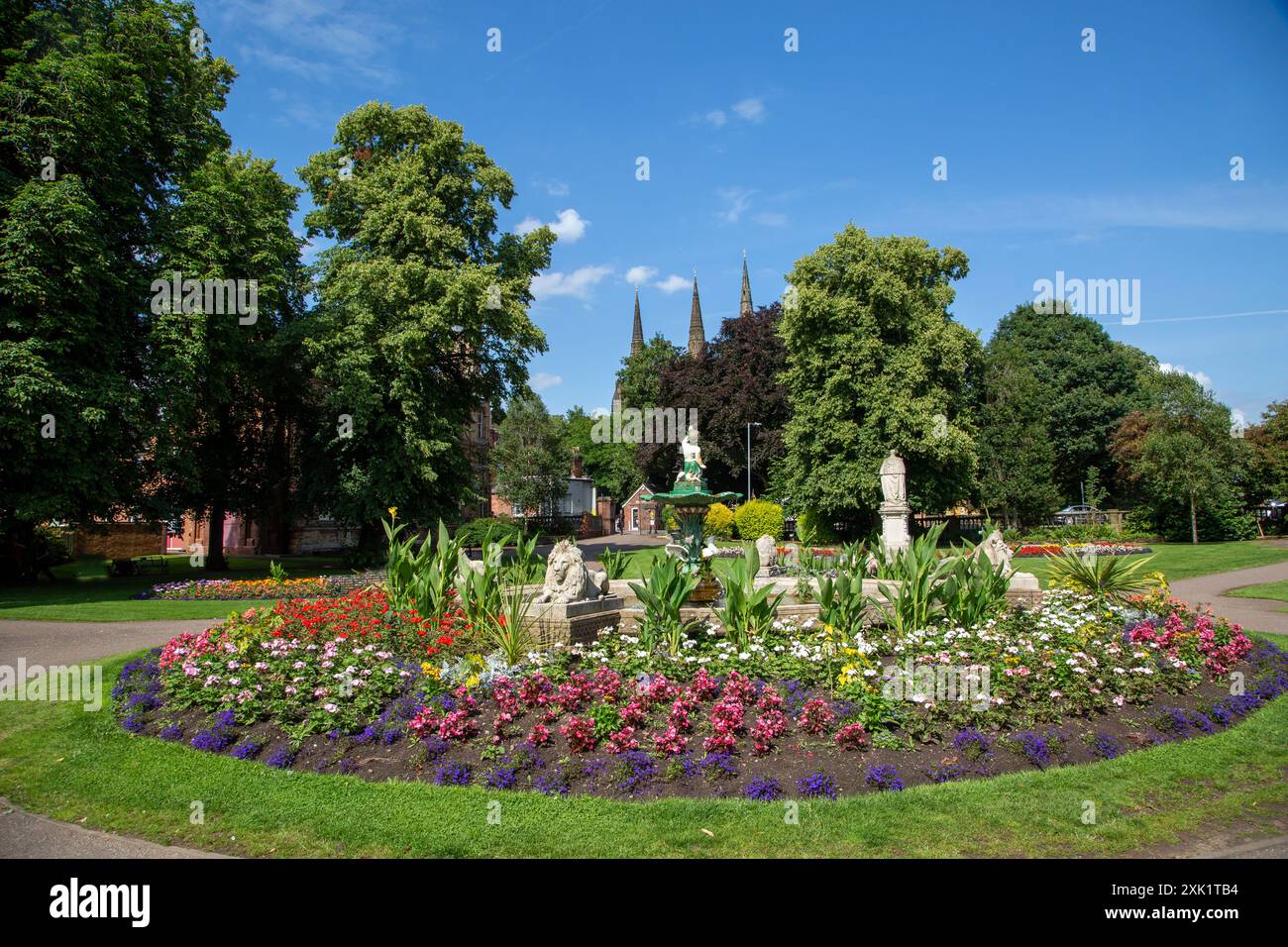 The three spires of Lichfield Cathedral seen from the summer floral ...