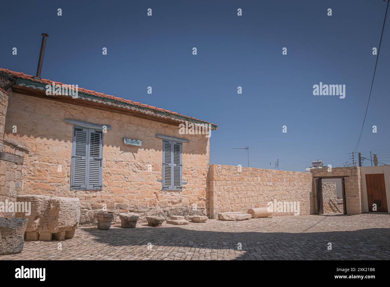 Rustic stone buildings with wooden doors and windows, set along a ...