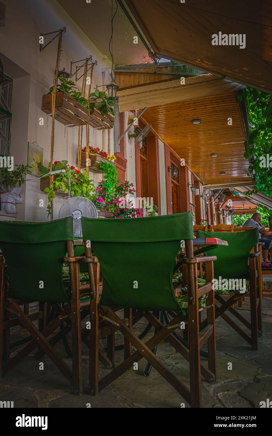 This image depicts a charming cafe patio with a cozy and inviting ...