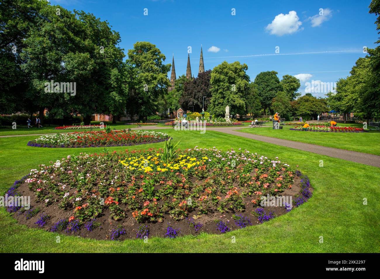 The three spires of Lichfield Cathedral seen from the summer floral ...