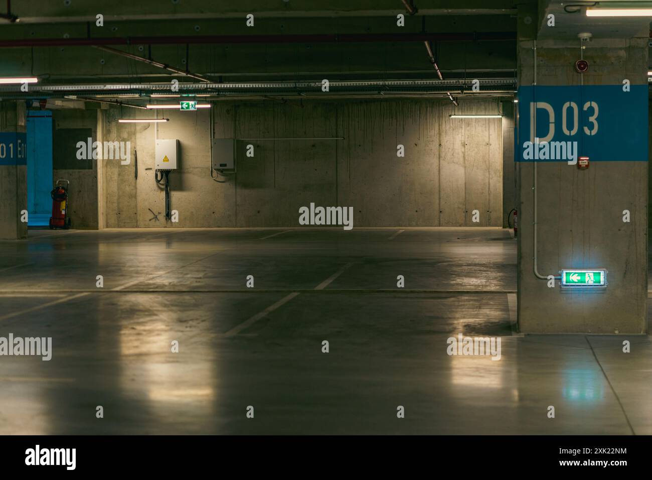 Empty underground garage. Parking lot with overhead dim light Stock ...
