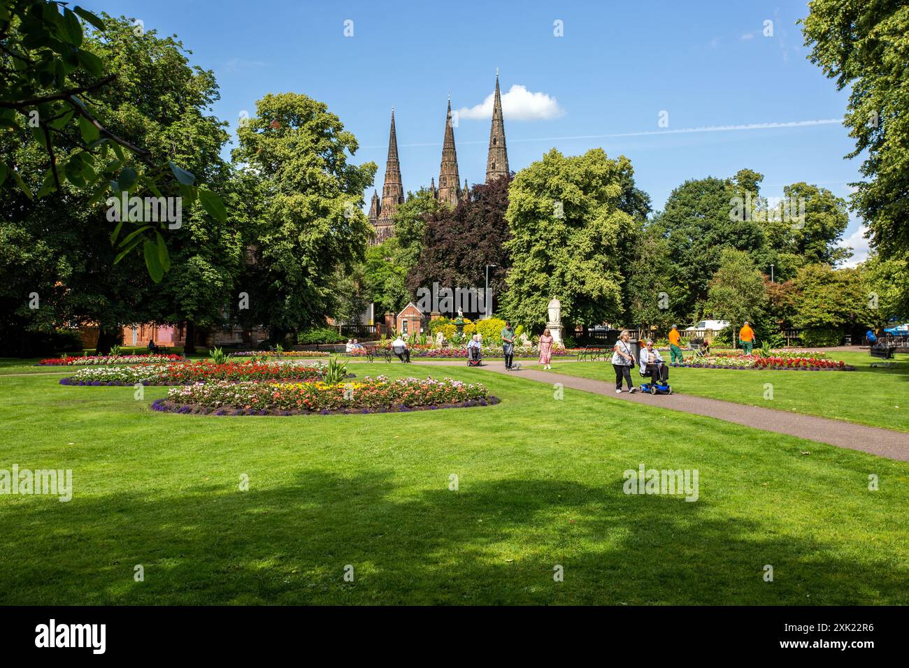 The three spires of Lichfield Cathedral seen from the summer floral ...